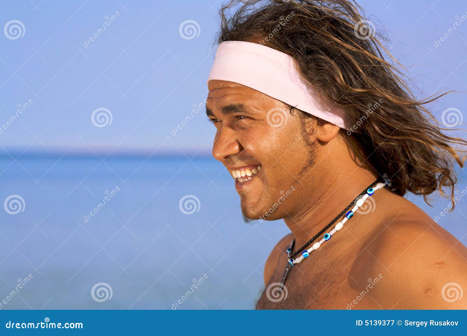 Smiling man on the beach stock image. Image of american - 5139377