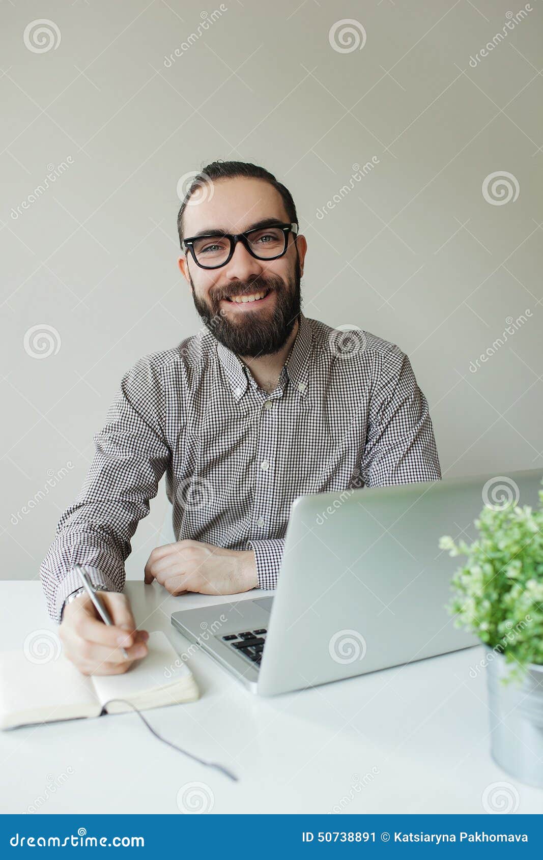 Smiling Man with Beard in Glasses Taking Notes with Laptop Notepad ...