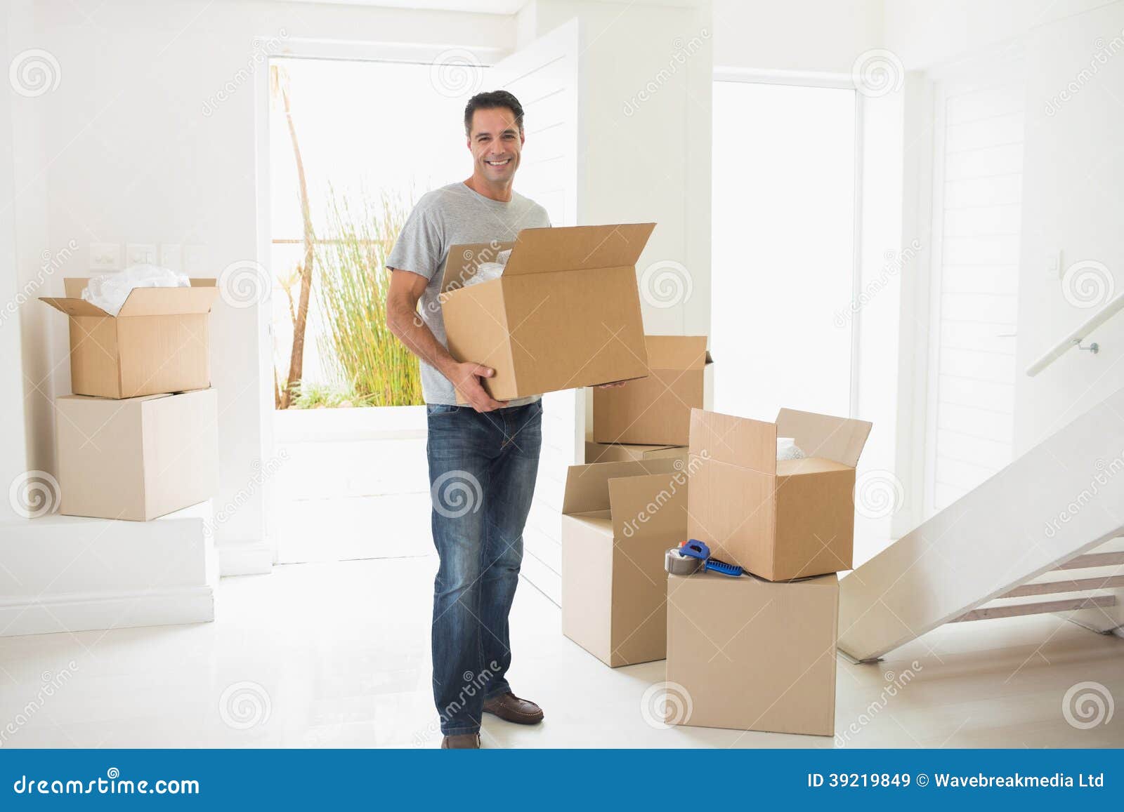 Smiling Man Carrying Boxes in a New House Stock Image - Image of mature ...
