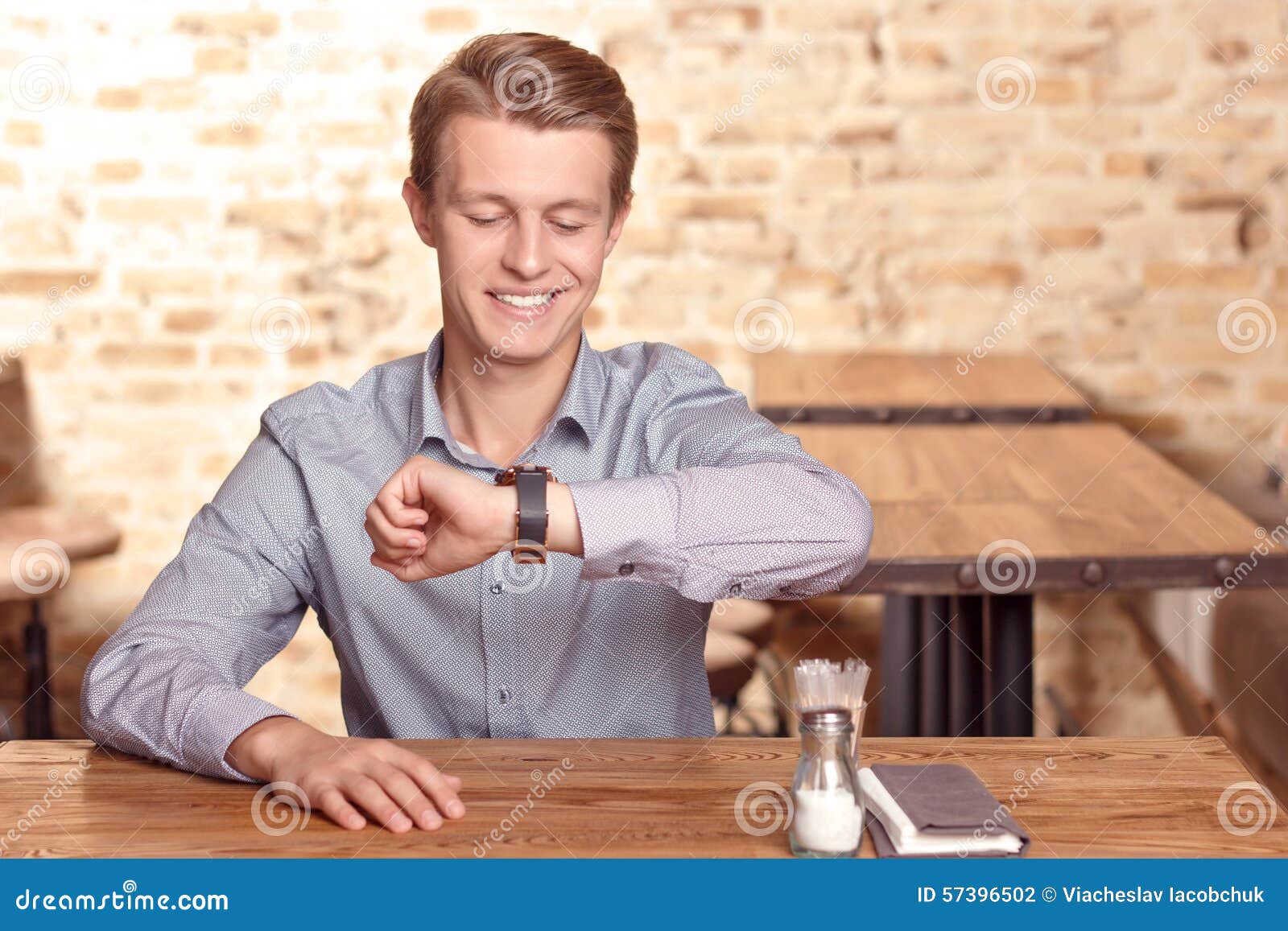 Smiling Man Checking Time in Cafe Stock Photo - Image of communication ...