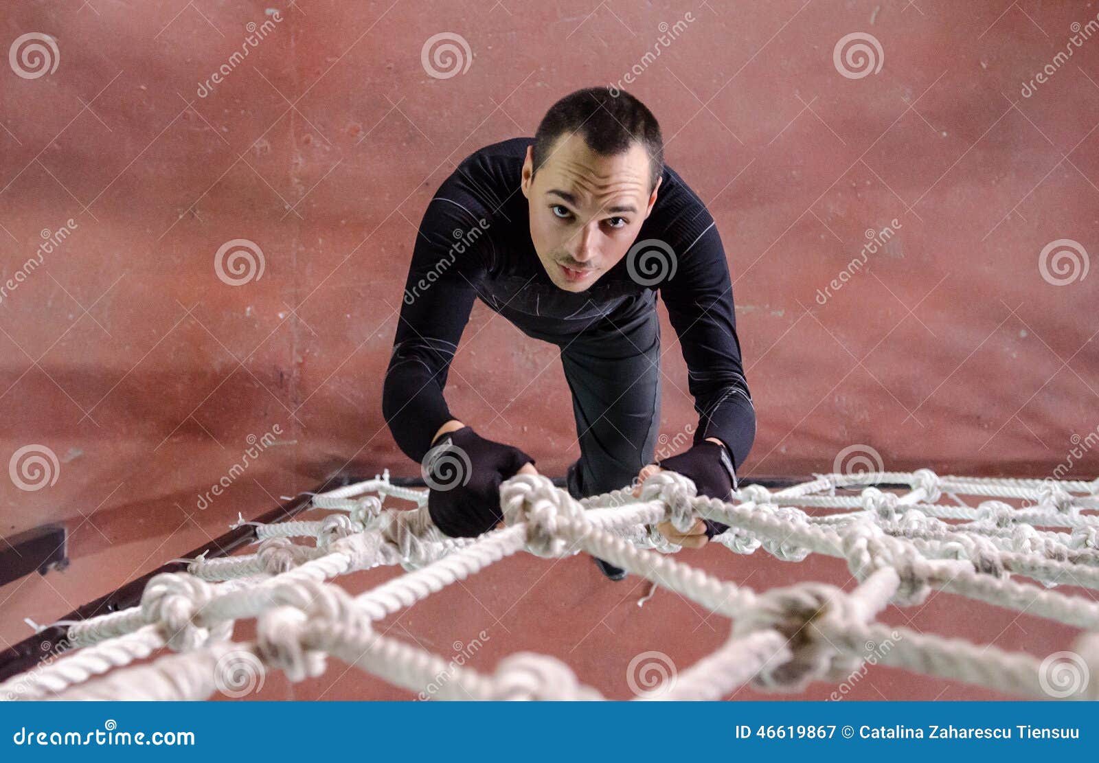 Smiling Man Climbing on Rope Net Stock Image - Image of bootcamp ...