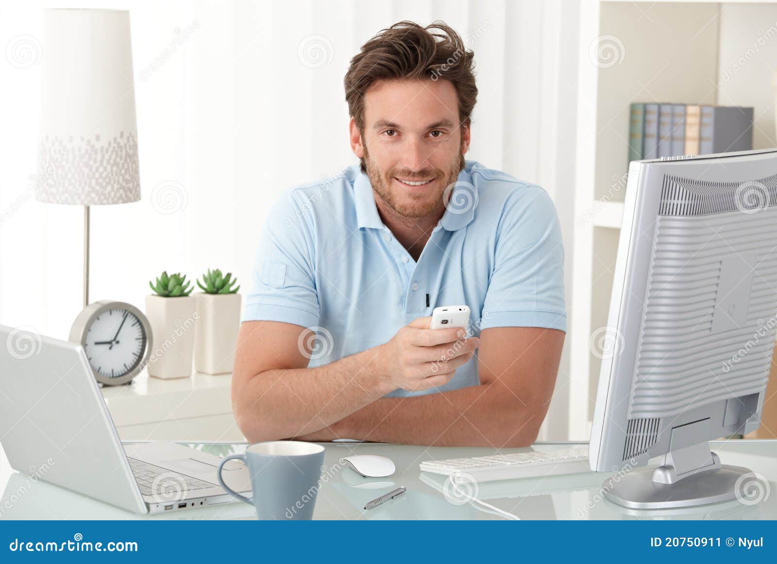 Smiling Man at Desk with Mobile Phone Stock Image - Image of handy ...