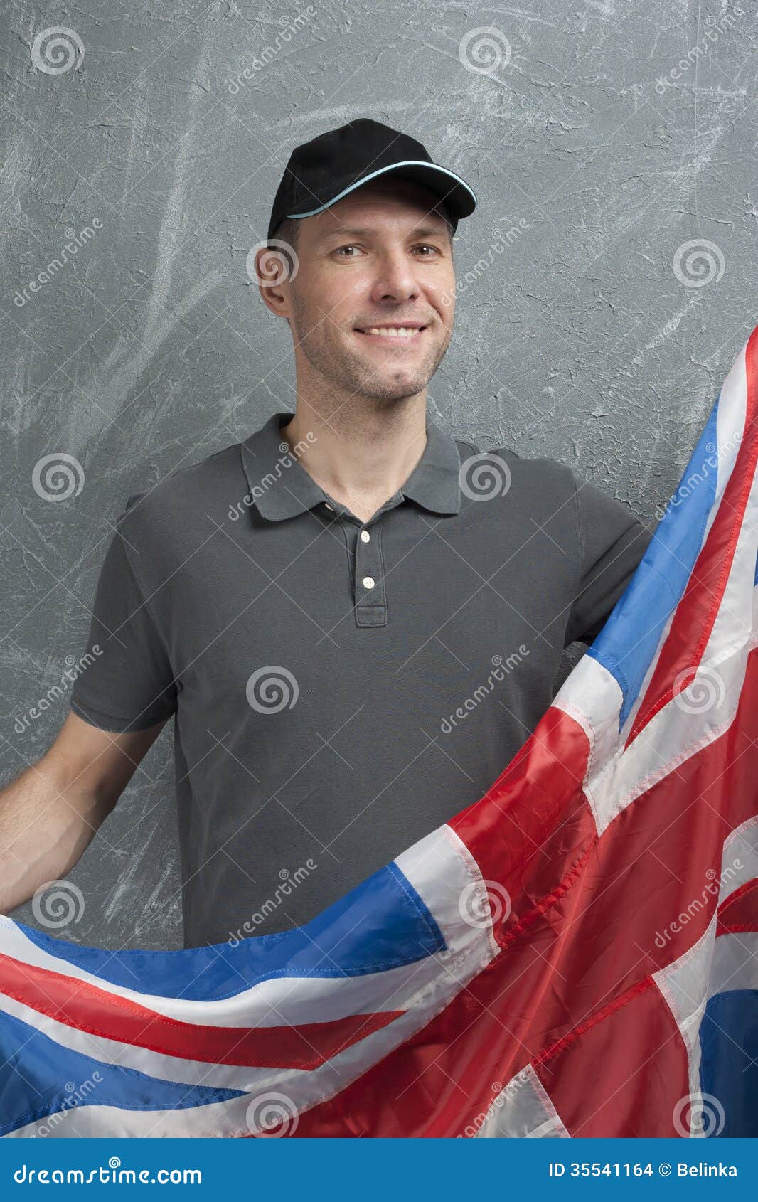 Smiling Man in Gray Against Background of British Flag Stock Photo ...
