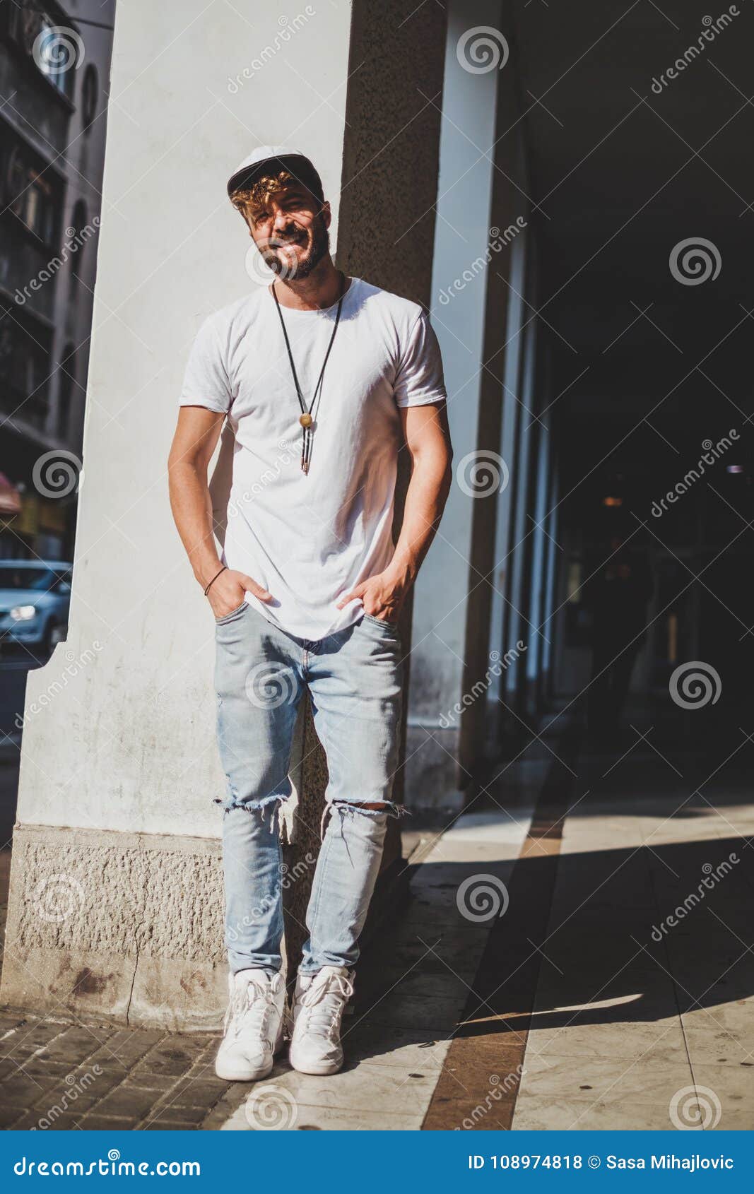 Smiling Man Leaning on Column by the Building Corridor Stock Photo ...