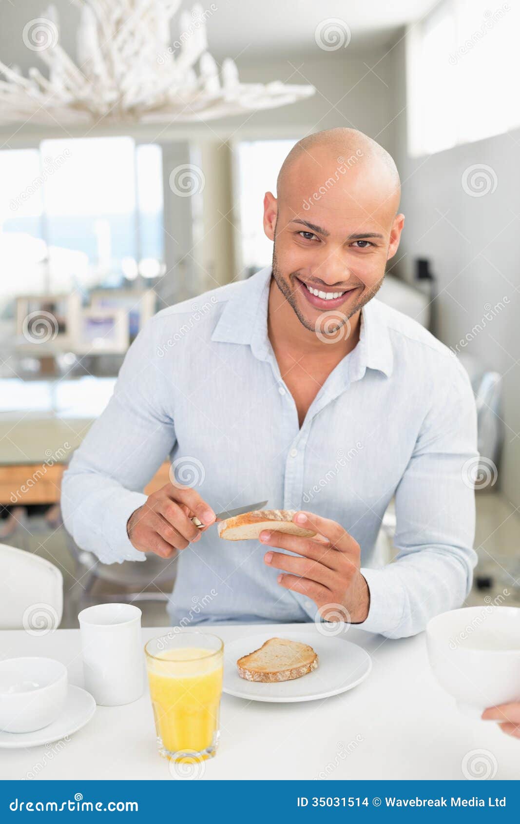 Smiling Man Having Breakfast at Home Stock Photo - Image of mixedrace ...