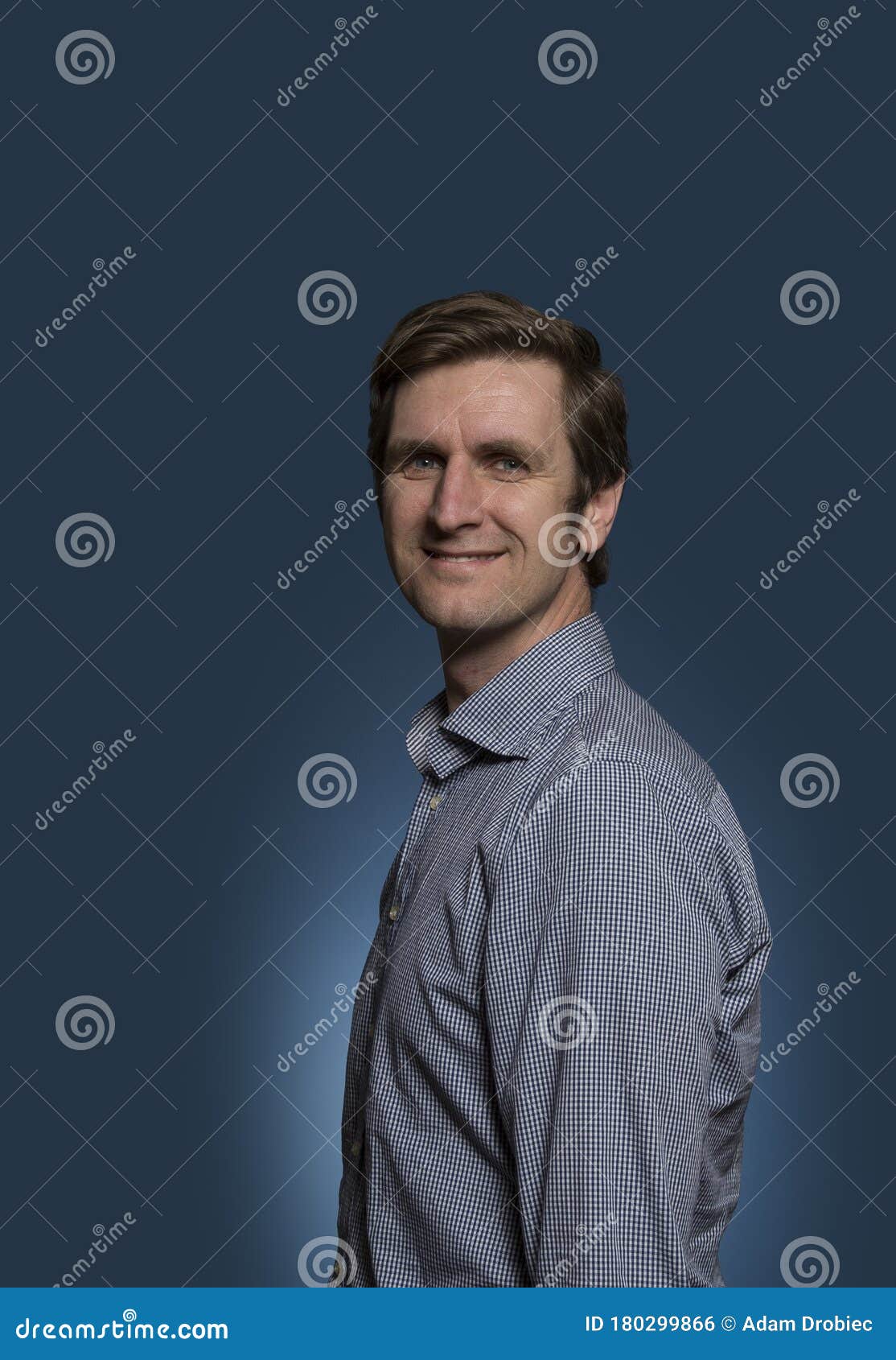 Smiling Man with Head Turned Towards Camera Stock Photo - Image of ...