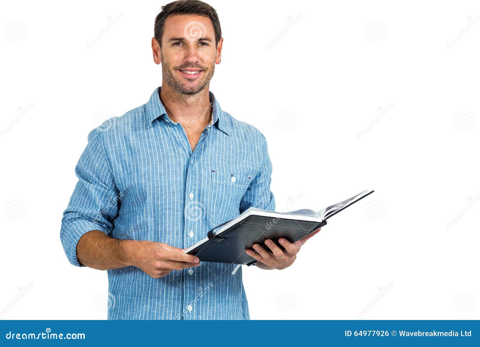 Smiling man holding book stock photo. Image of businessman - 64977926