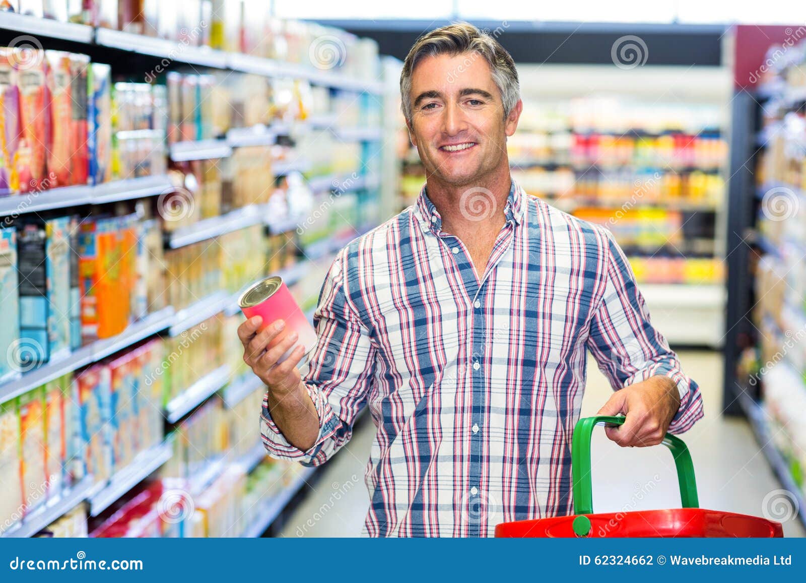 Smiling man holding can stock photo. Image of clothing - 62324662