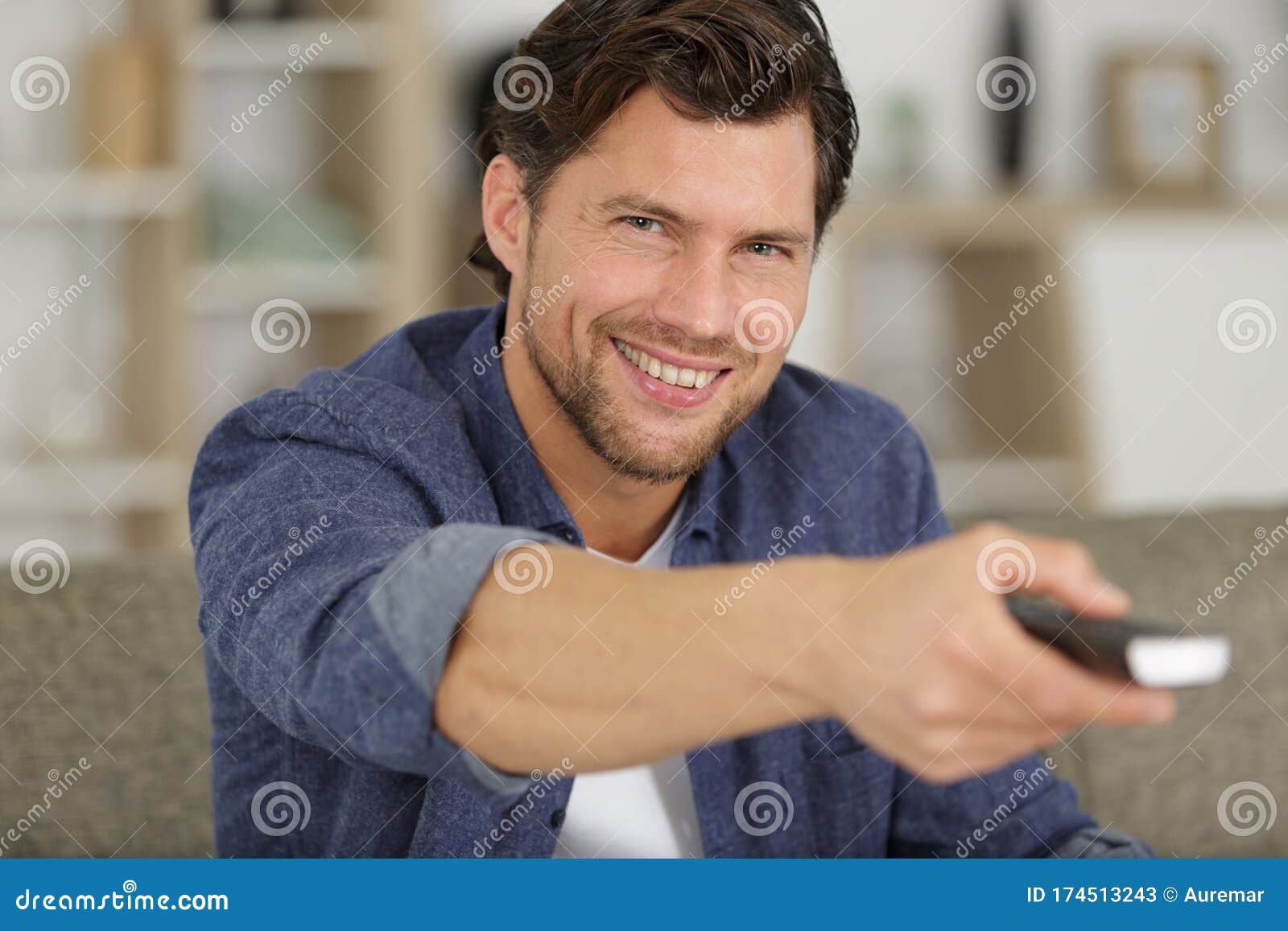 Smiling Man Holding Remote Control Stock Image - Image of adult ...
