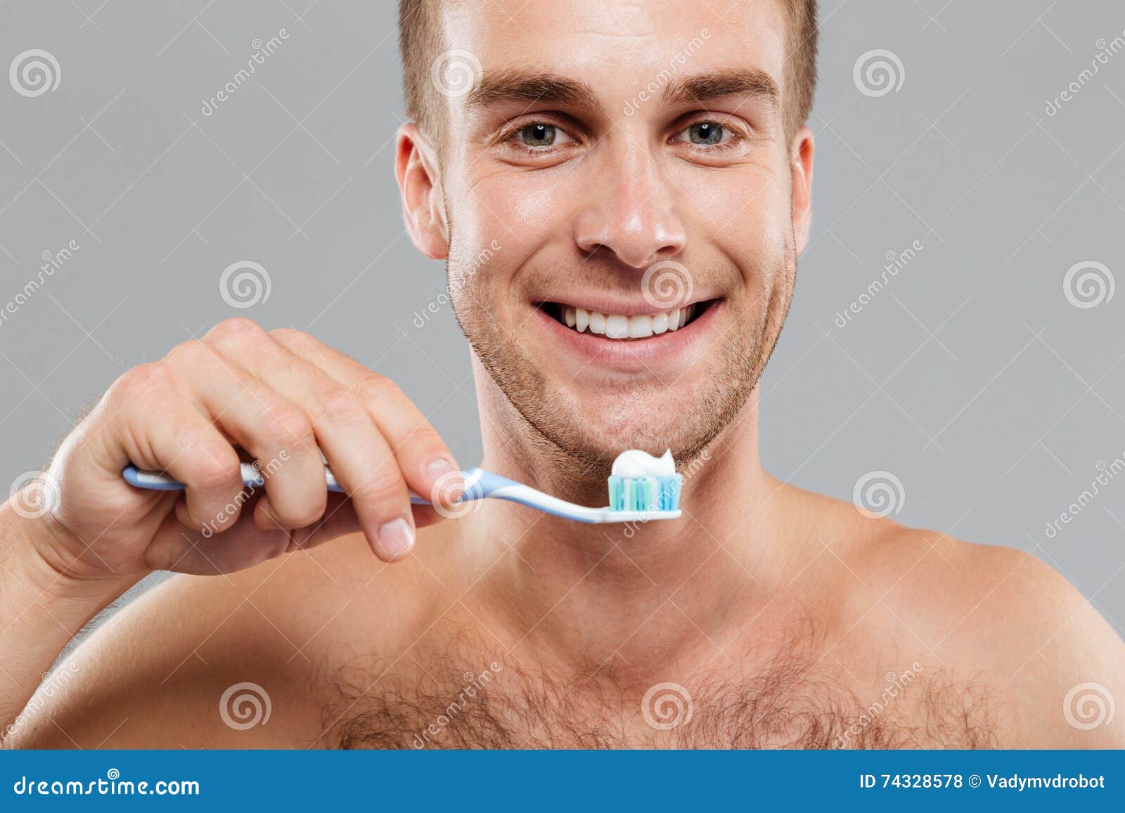 Smiling Man Holding Toothbrush with Toothpaste and Cleaning His Teeth ...