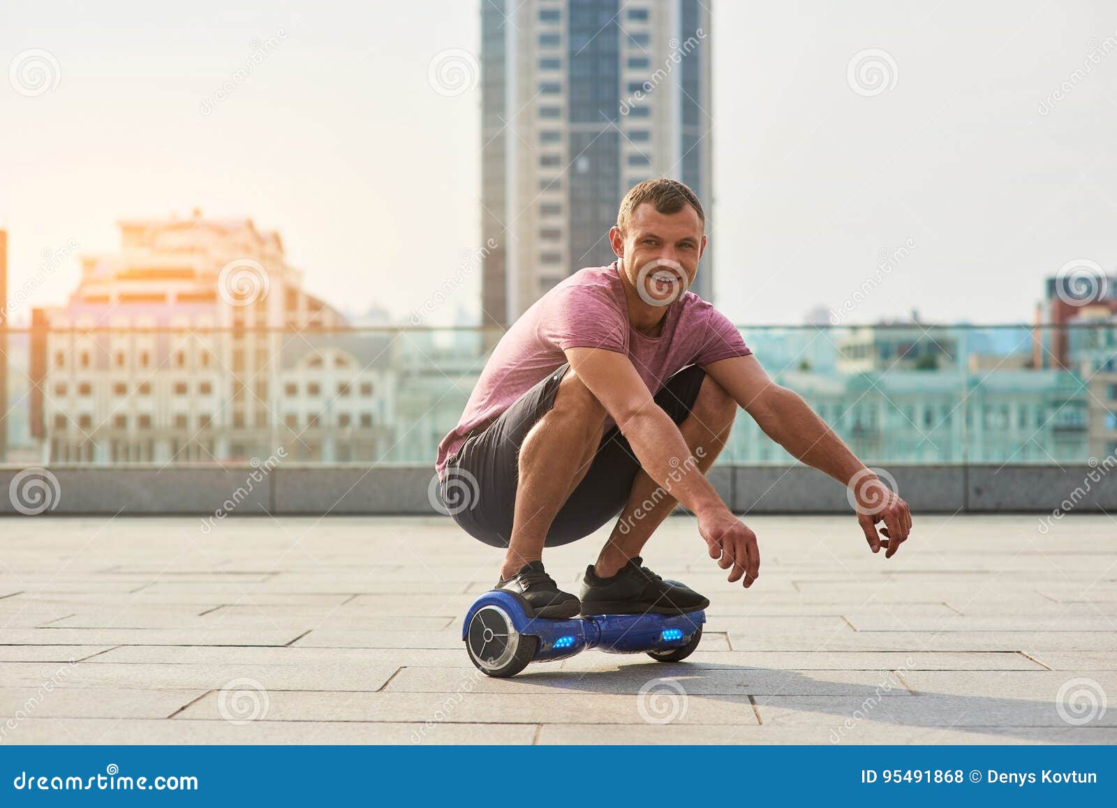 Smiling man on hoverboard. stock photo. Image of lifestyle - 95491868