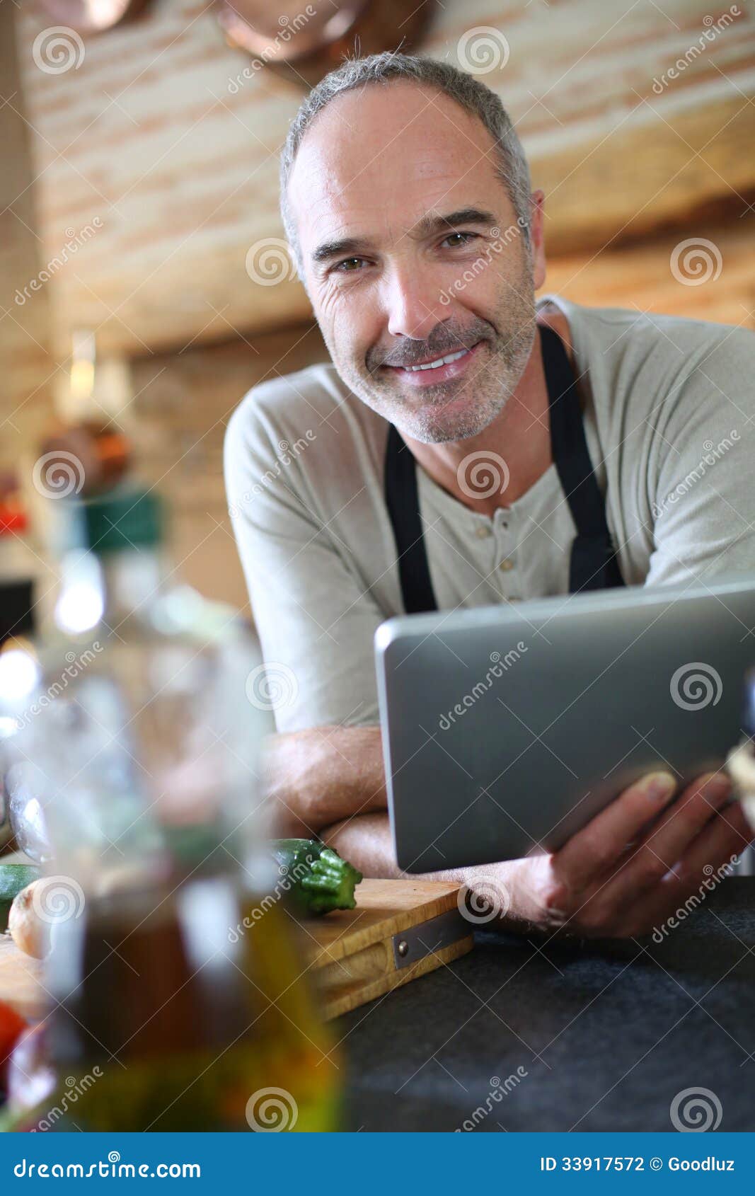 Smiling Man in Kitchen Checking Recipe on Internet Stock Photo - Image ...