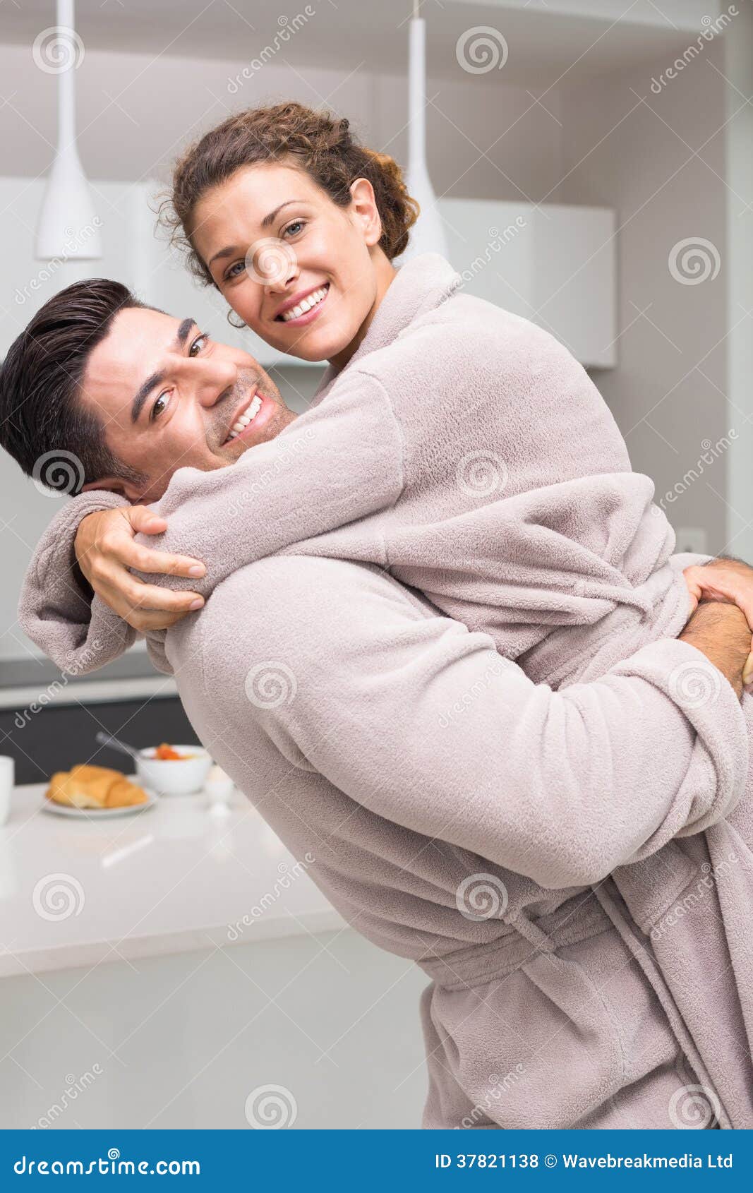 Smiling Man Lifting and Hugging His Partner in the Morning Stock Photo ...