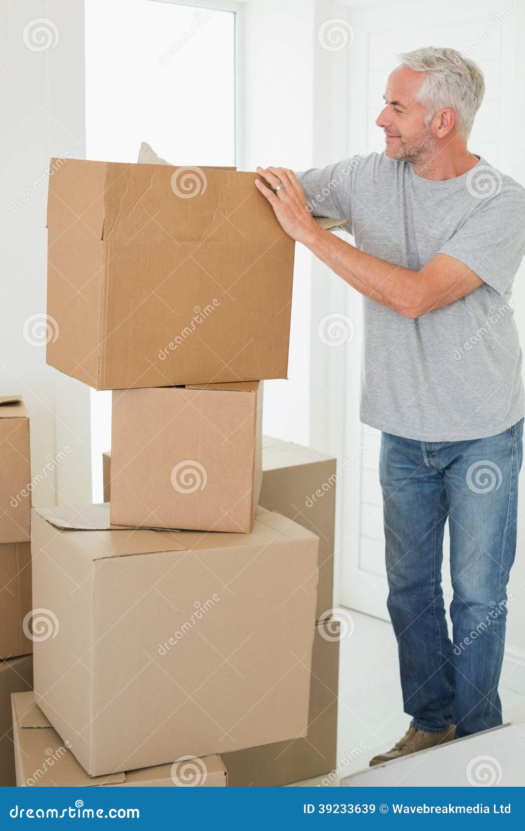 Smiling Man Looking at Cardboard Moving Boxes Stock Image - Image of ...