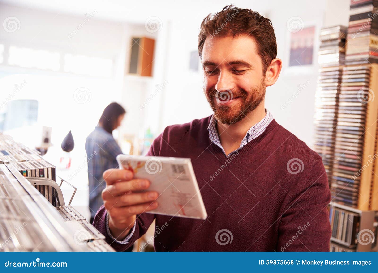 Smiling Man Looking at a CD in a Record Shop Stock Photo - Image of ...