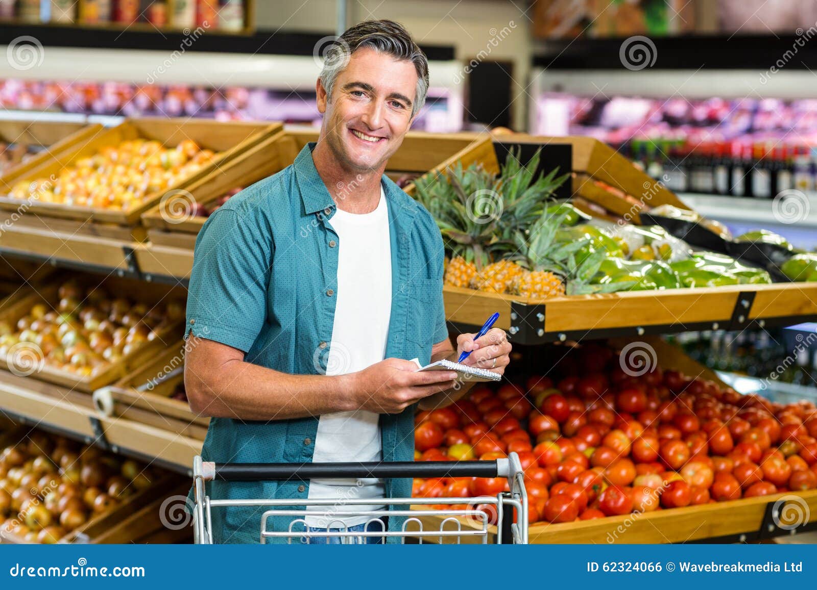 Smiling Man Looking at His List Stock Photo - Image of store, grocery ...