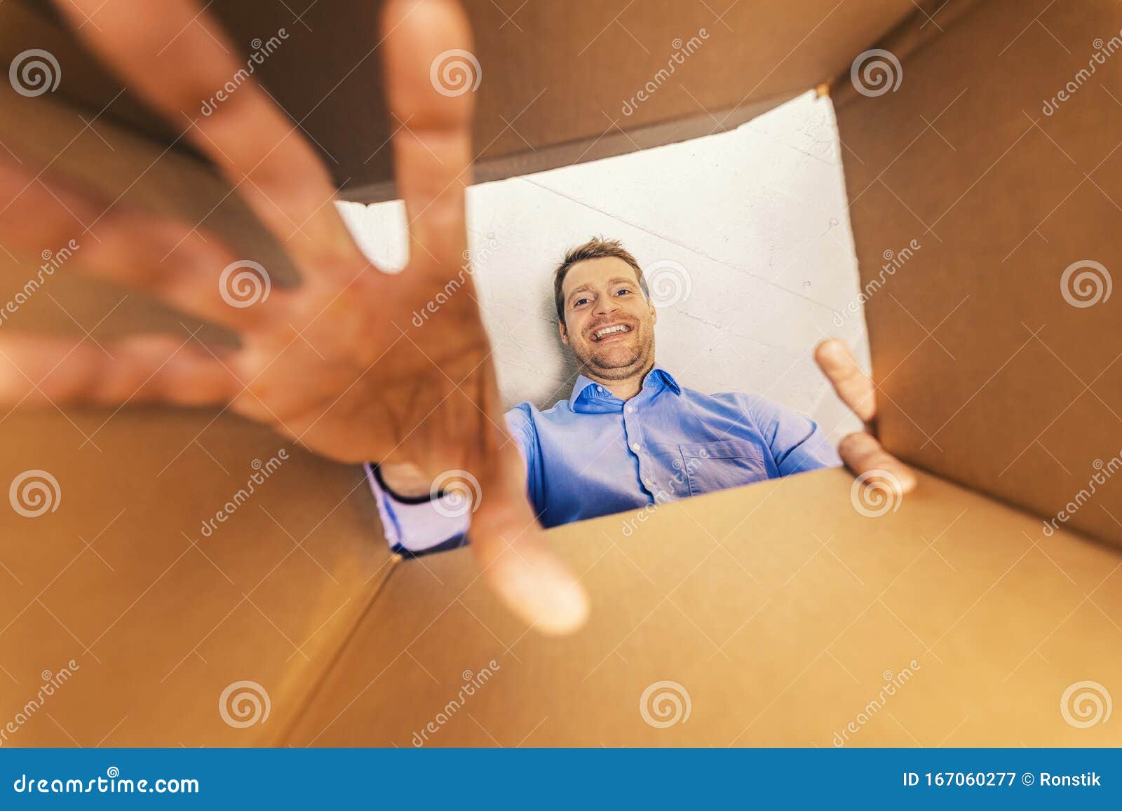Smiling Man Looking Inside the Box and Reaching for Goods Stock Image ...