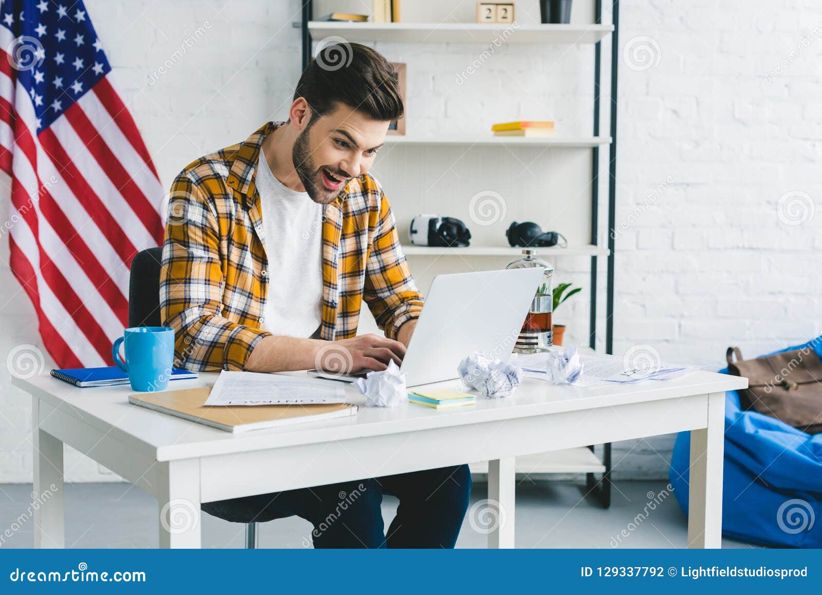 Smiling Man Looking at Laptop Screen Stock Photo - Image of documents ...