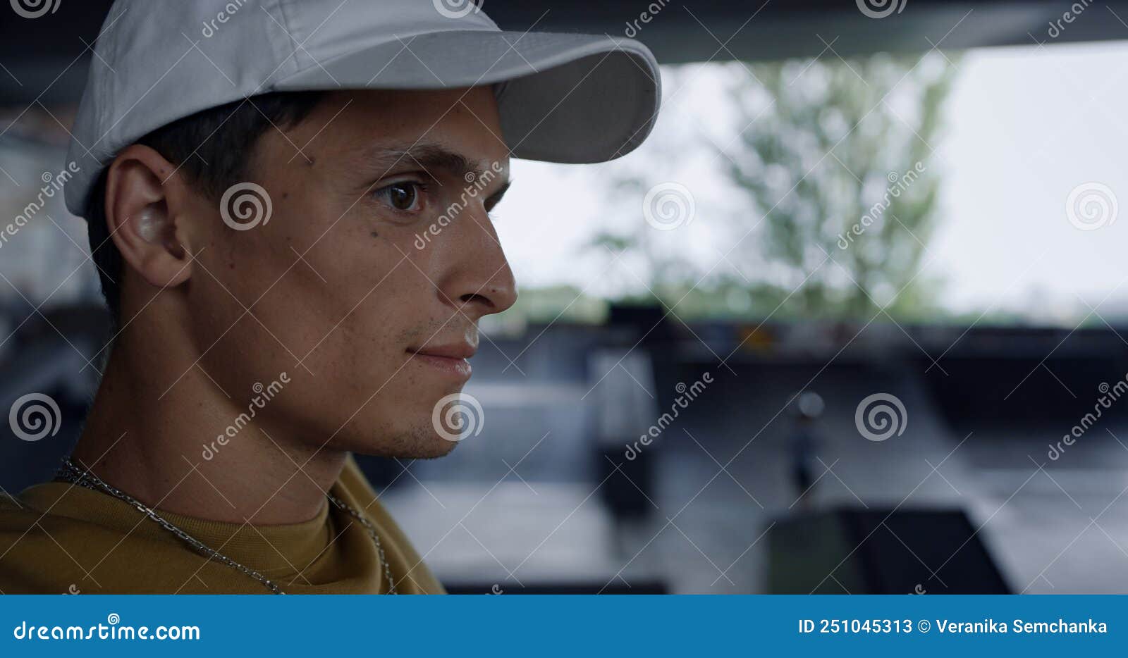 Smiling Man Looking Training at Skatepark. Side View Guy Looking ...