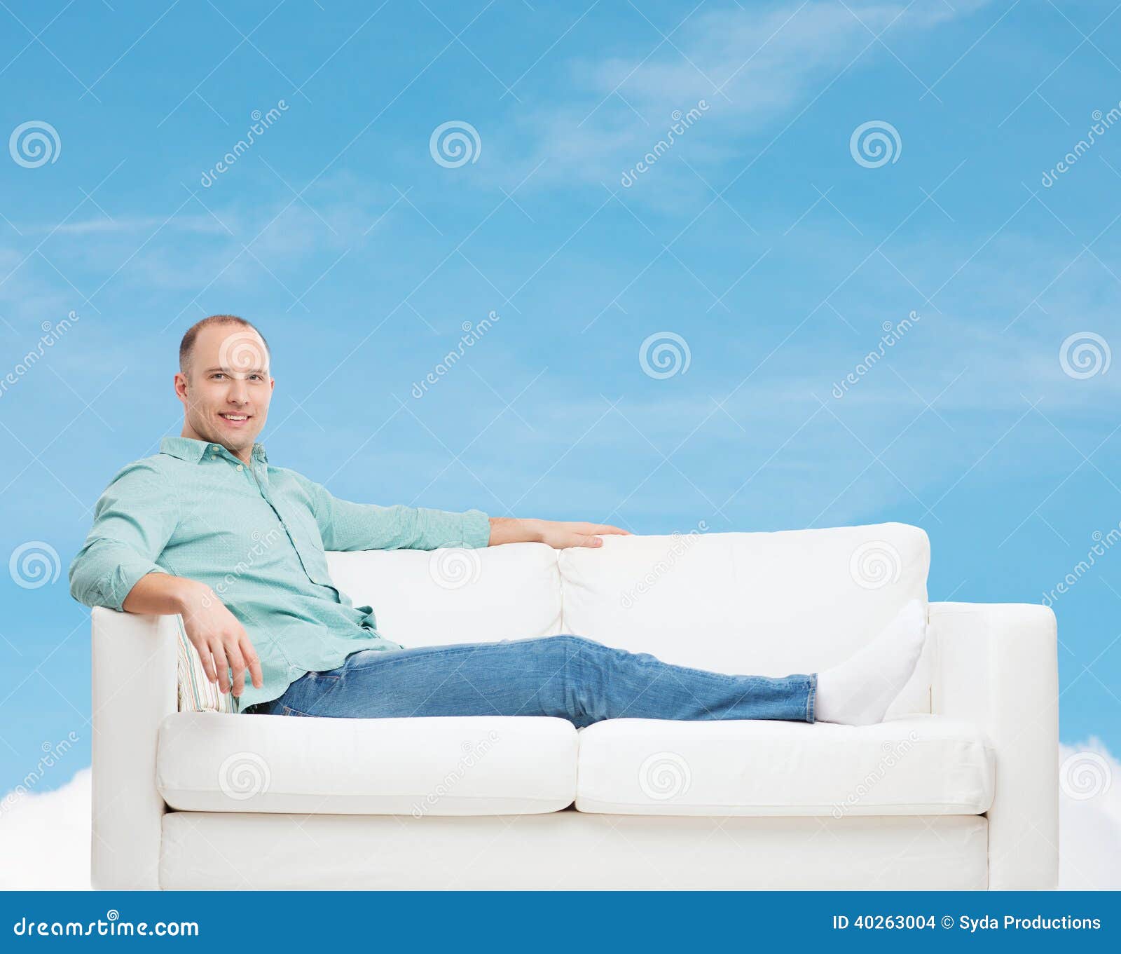 Smiling man lying on sofa stock photo. Image of pleasure - 40263004
