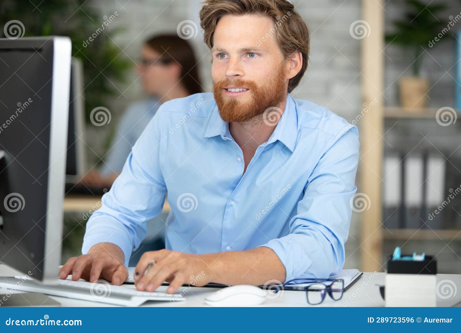 Smiling Man at Office Desk Using Computer Stock Photo - Image of ...