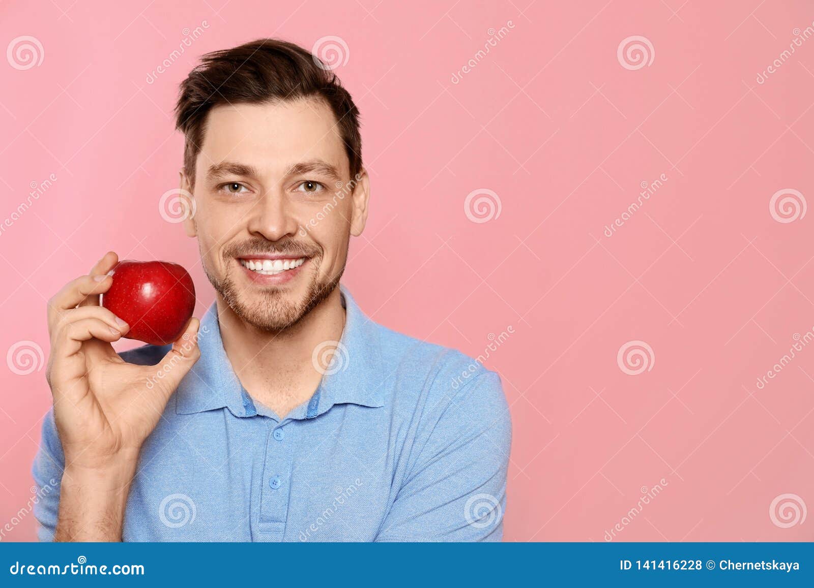 Smiling Man with Perfect Teeth and Red Apple on Color Background. Stock ...