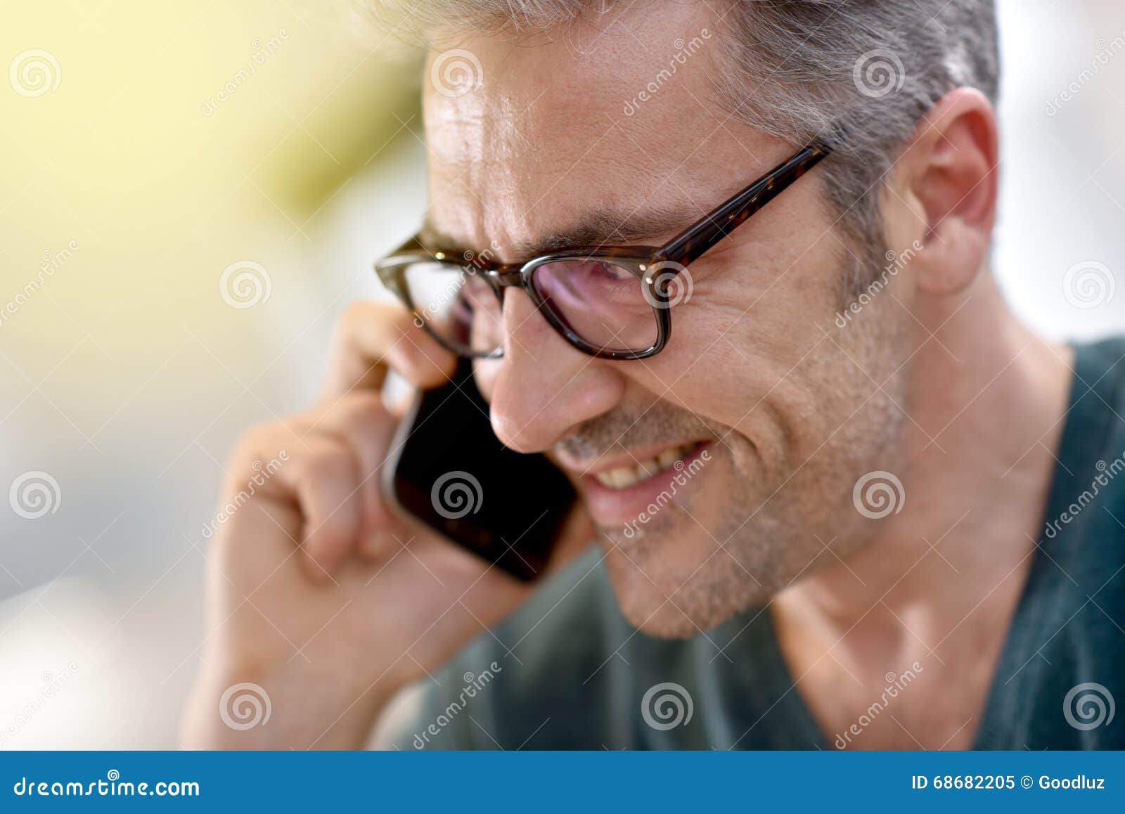 Smiling man on the phone stock image. Image of eyeglasses - 68682205