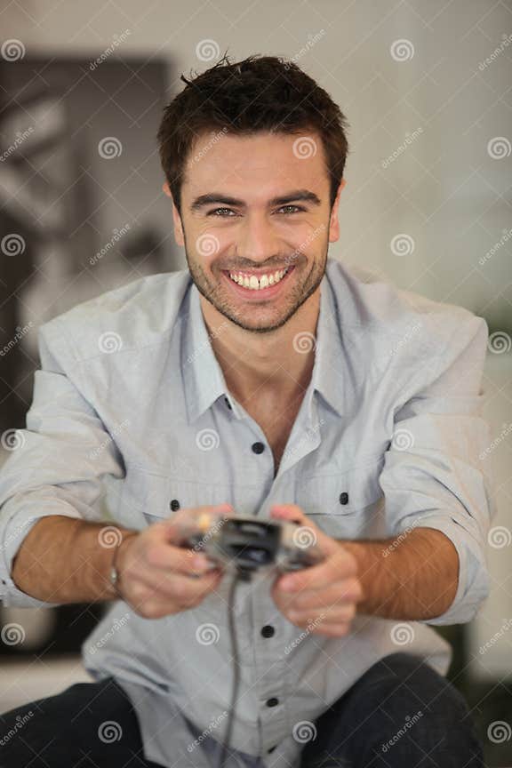Smiling man playing games stock photo. Image of domestic - 24016596