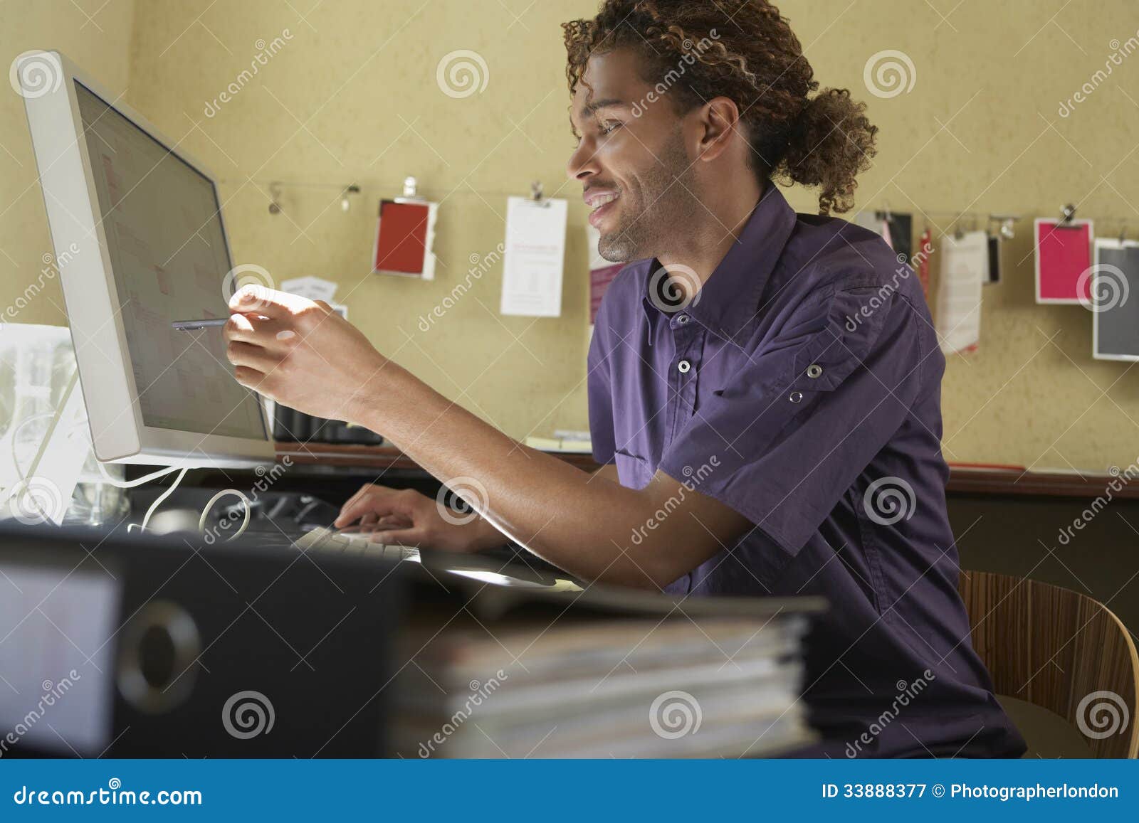 Smiling Man Pointing at Computer Screen in Office Stock Image - Image ...