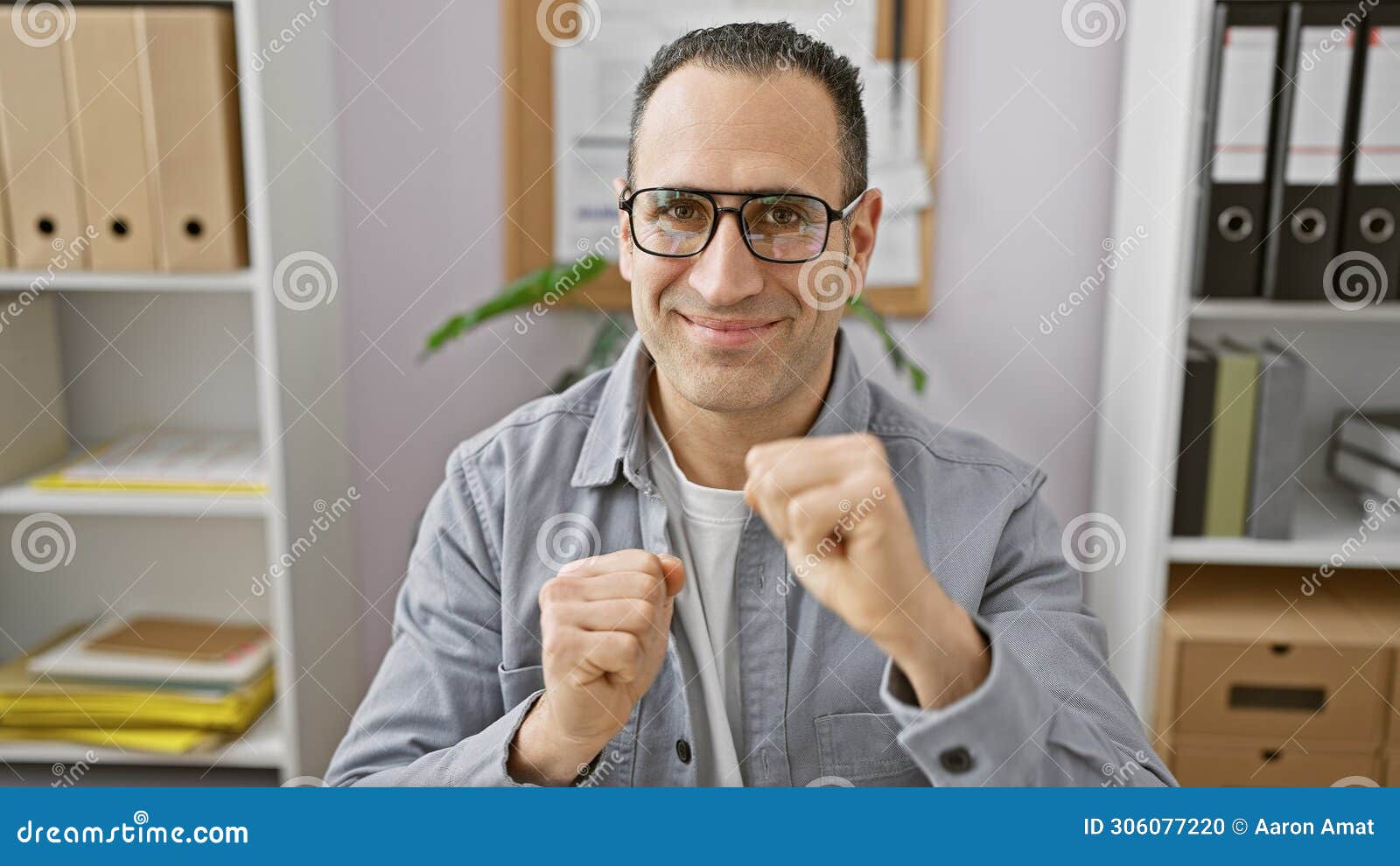 A Smiling Man Poses Confidently in a Modern Office, Conveying Optimism ...