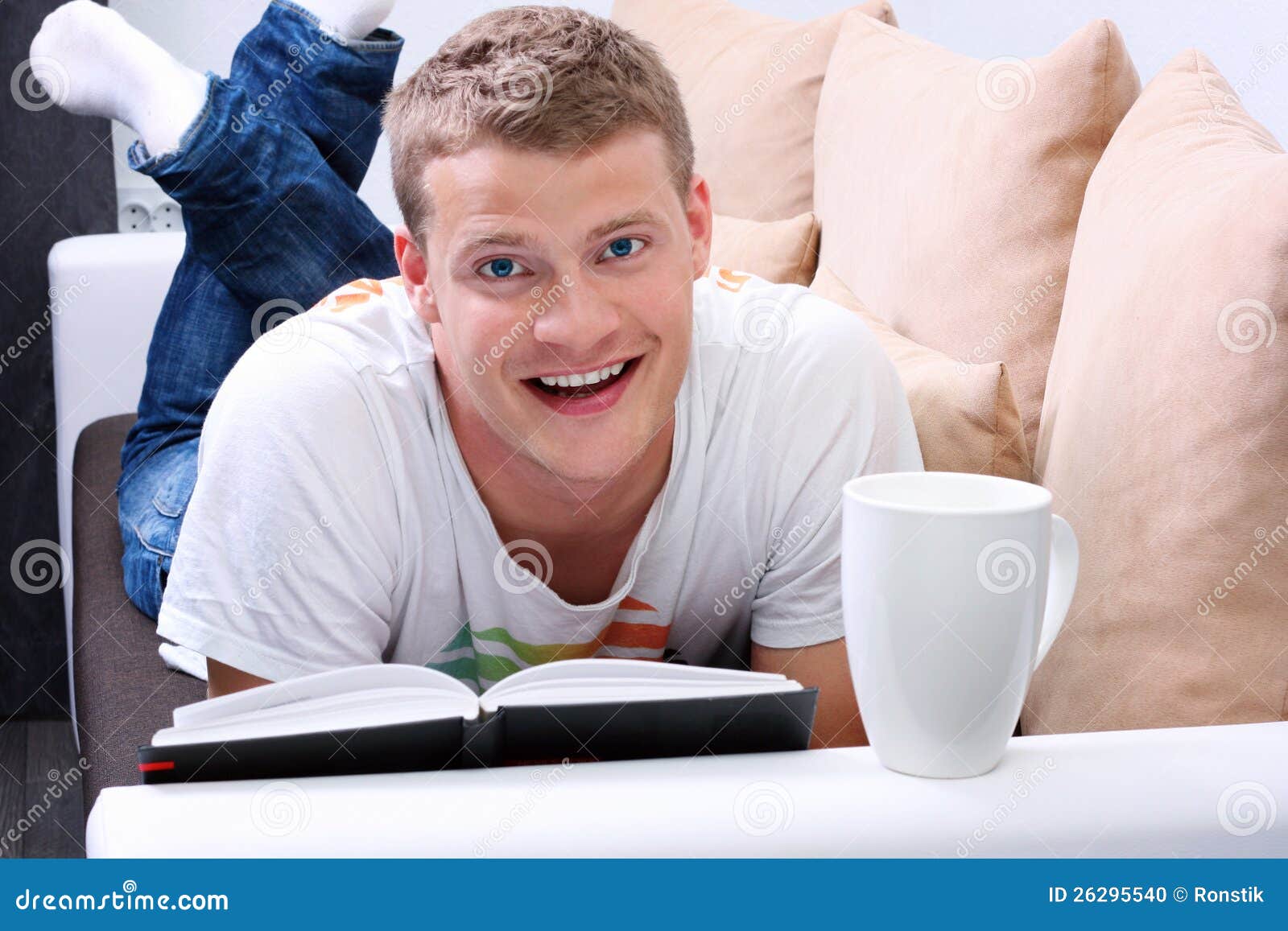 Smiling Man Reading a Book and Relaxing on Sofa Stock Photo - Image of ...