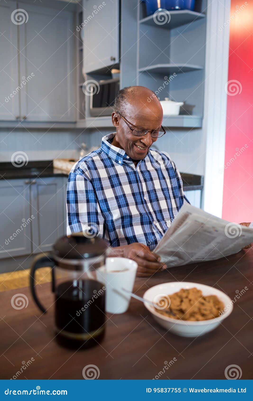 Smiling Man Reading Newspaper while Having Breakfast Stock Image ...