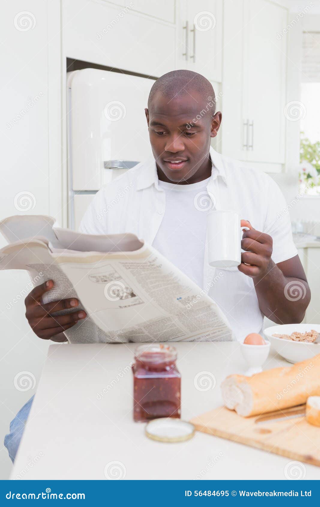 Smiling Man Reading a Newspaper and Taking His Breakfast Stock Image ...