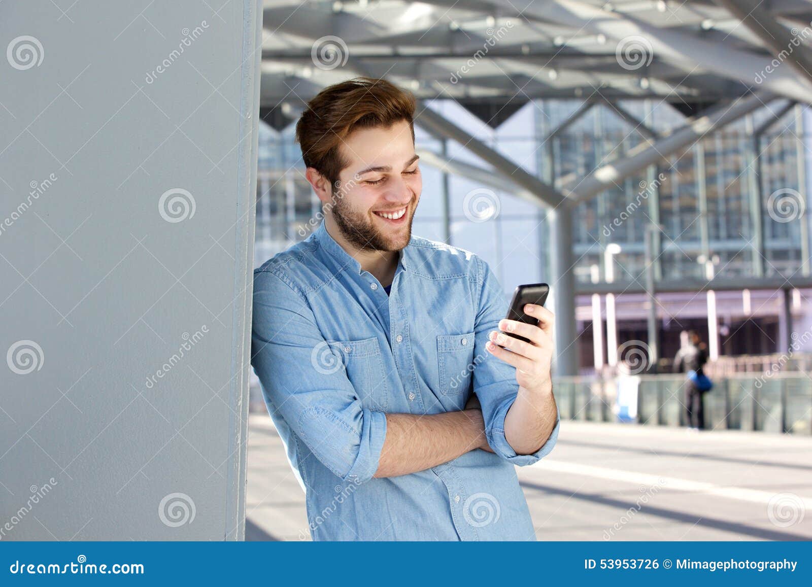 Smiling Man Reading Text Message on Mobile Phone Stock Photo - Image of ...