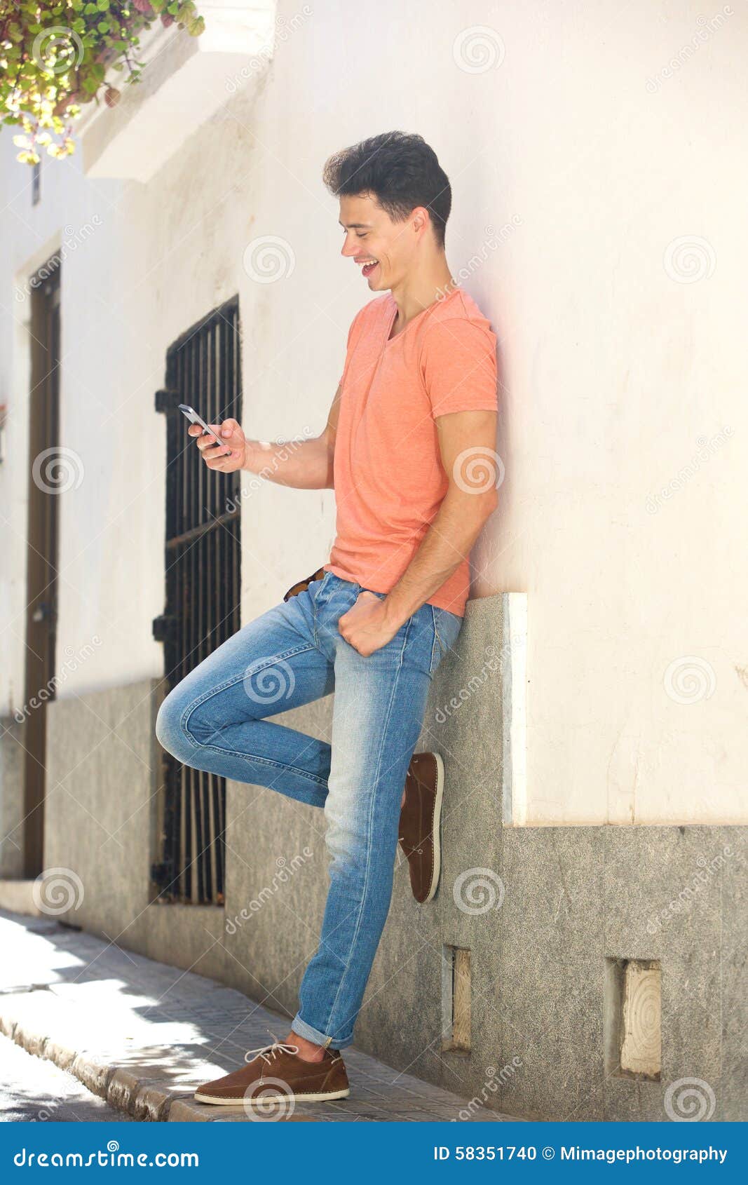 Smiling Man Reading Text Message on Mobile Phone Stock Photo - Image of ...