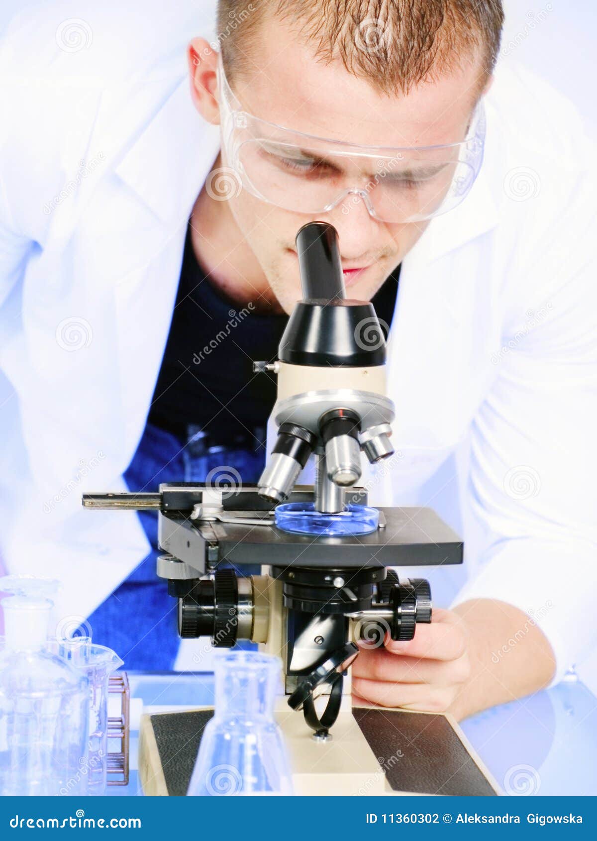 Smiling Man Researching on a Microscope Stock Photo - Image of medicine ...