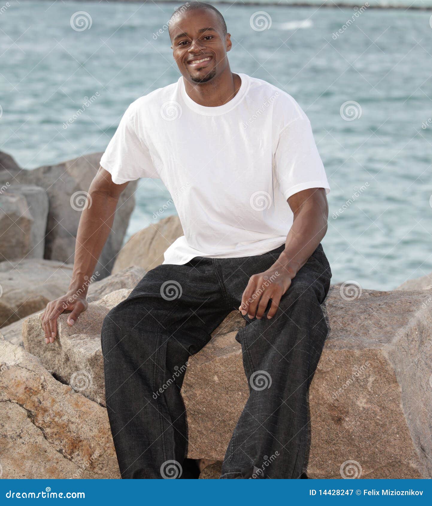 Smiling man on the rocks stock image. Image of african - 14428247