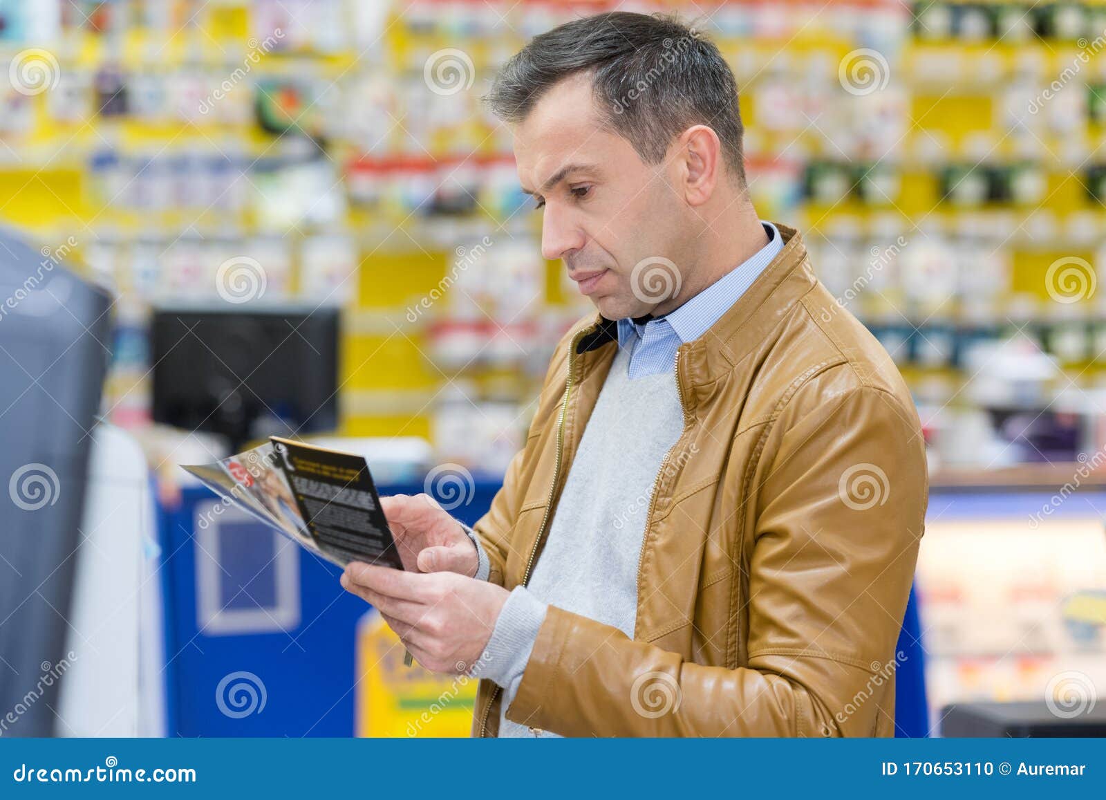 Smiling Man Selecting Product in Supermarket Stock Photo - Image of ...