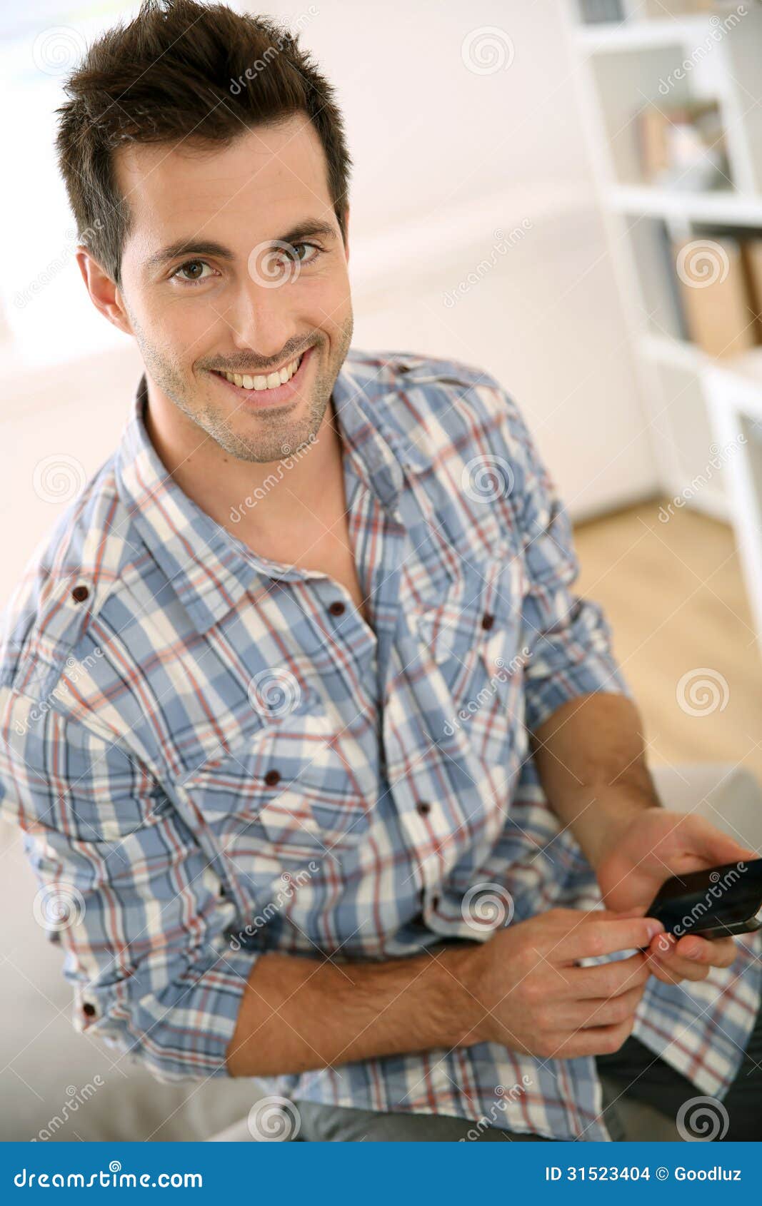 Smiling Man Sending Short Message from Home Stock Photo - Image of ...