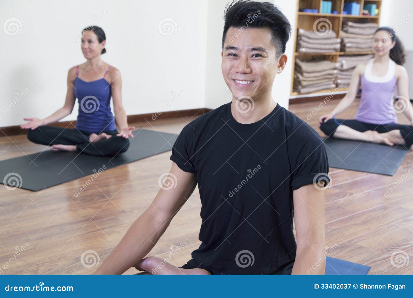 Smiling Man Sitting Cross-legged in a Yoga Class Stock Image - Image of ...