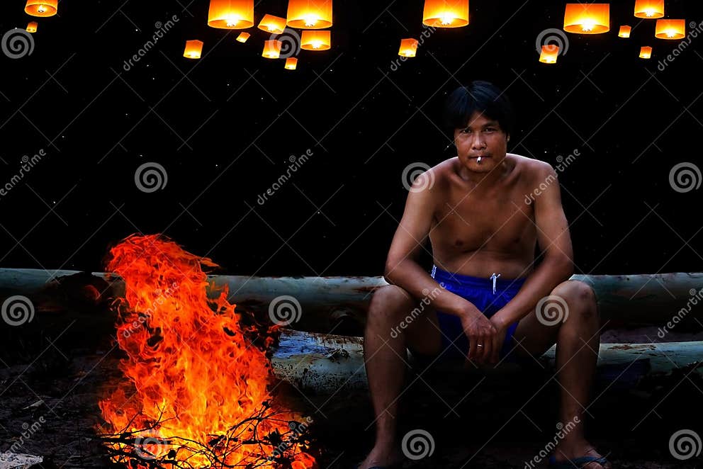 Smiling Man Sitting by the Fire Stock Photo - Image of person, fire ...