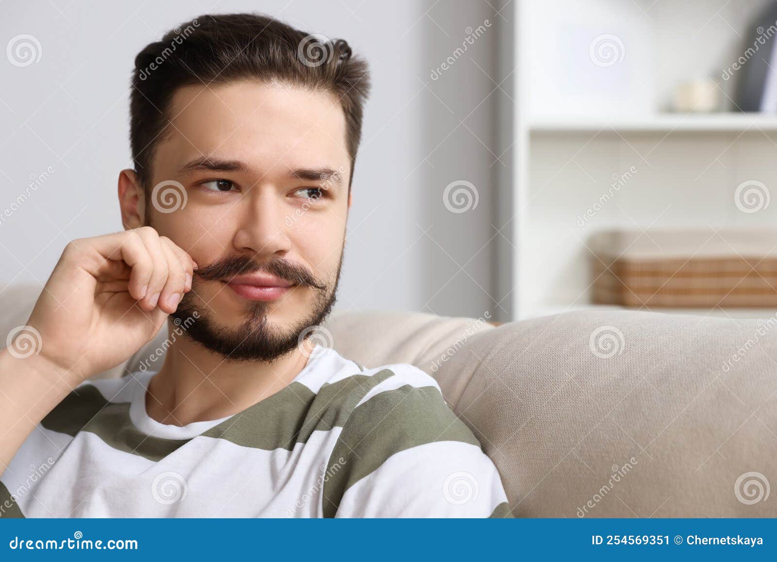 Smiling Man Sitting on Sofa in Room. Space for Text Stock Image - Image ...