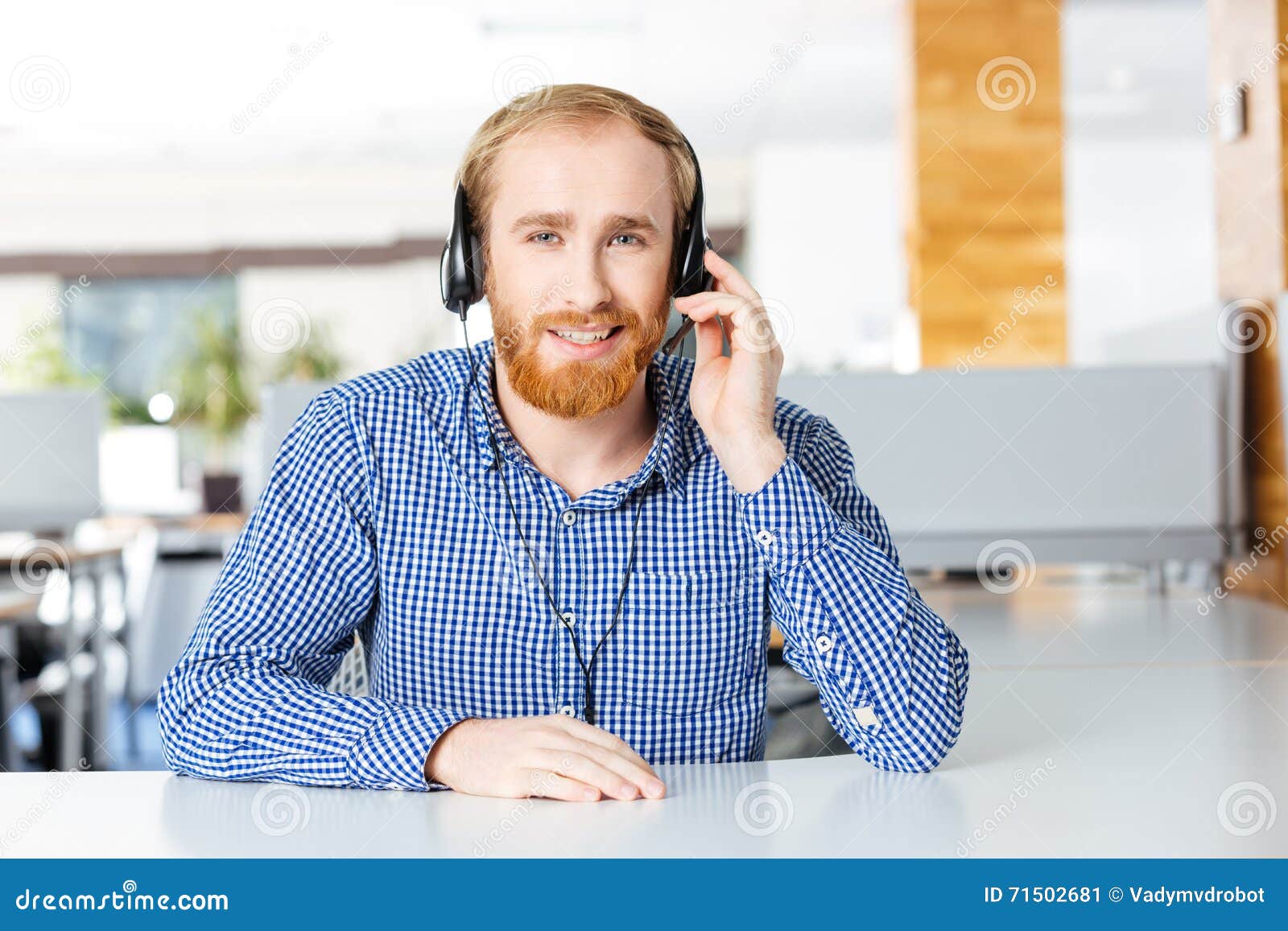 Smiling Man Sitting on Workplace and Using Headset Stock Image - Image ...