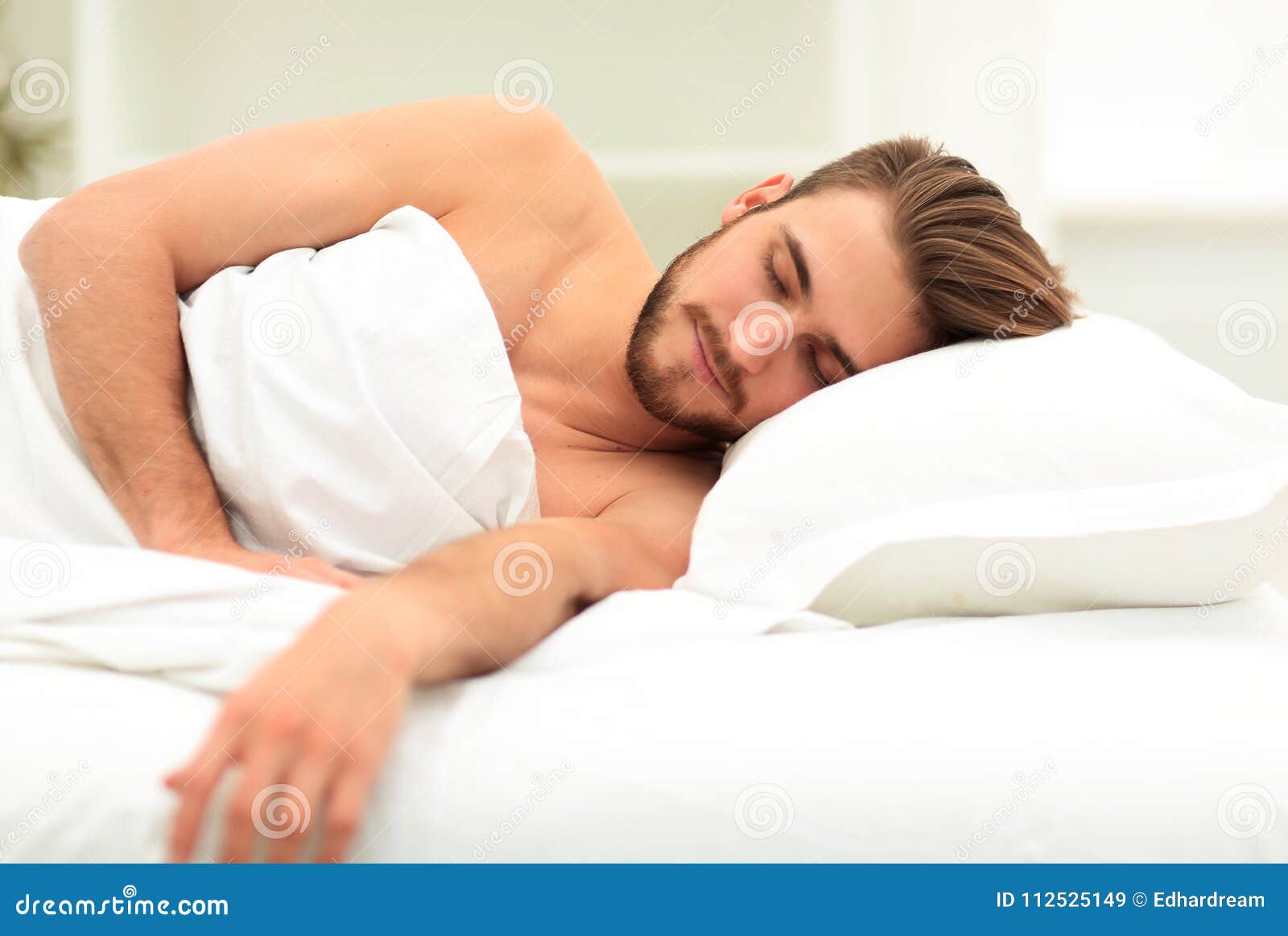 Smiling Man Sleeping on a Comfortable Bed. Stock Image - Image of ...