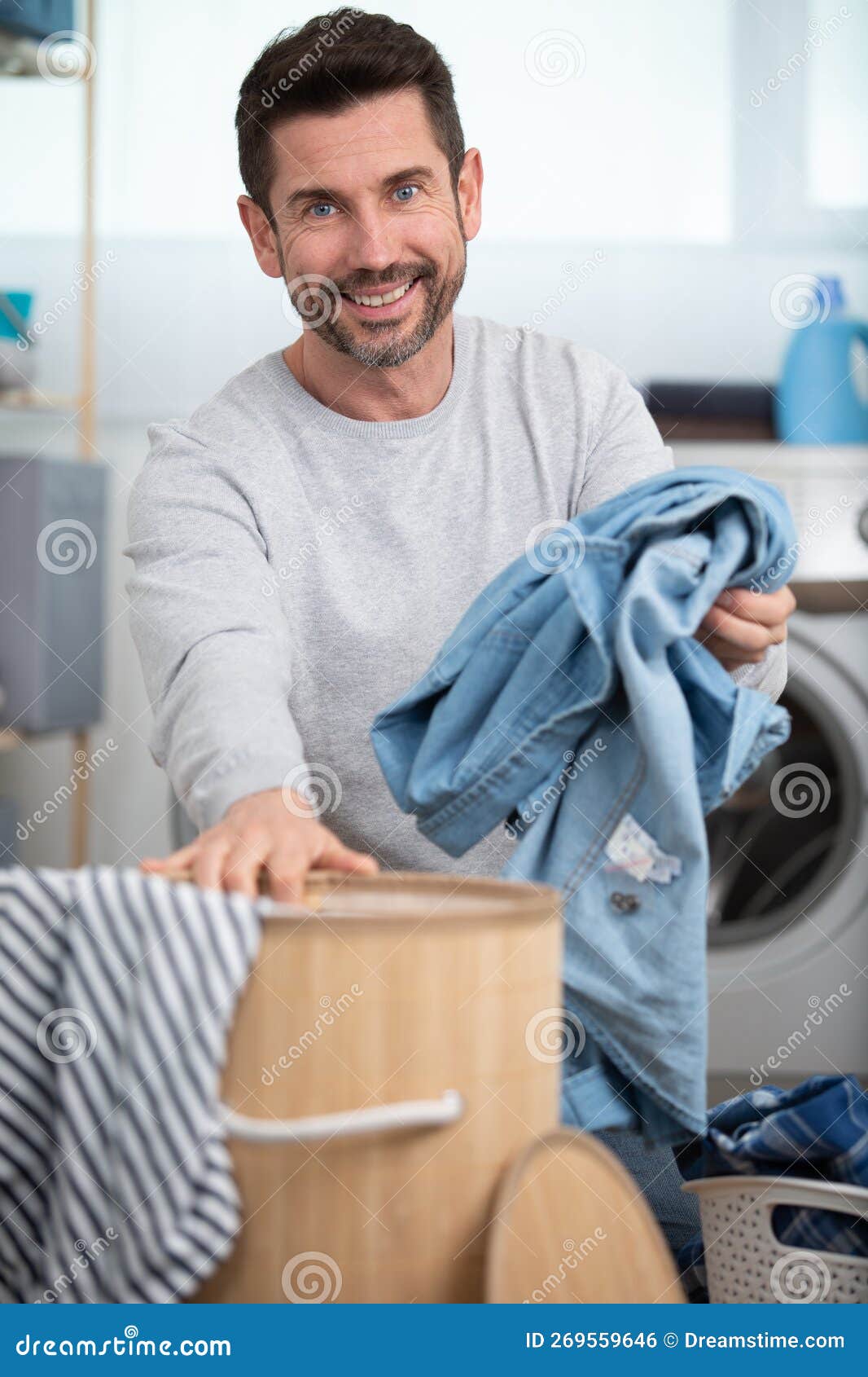 Smiling Man Sorting Out Laundry Stock Photo - Image of dryer, caucasian ...