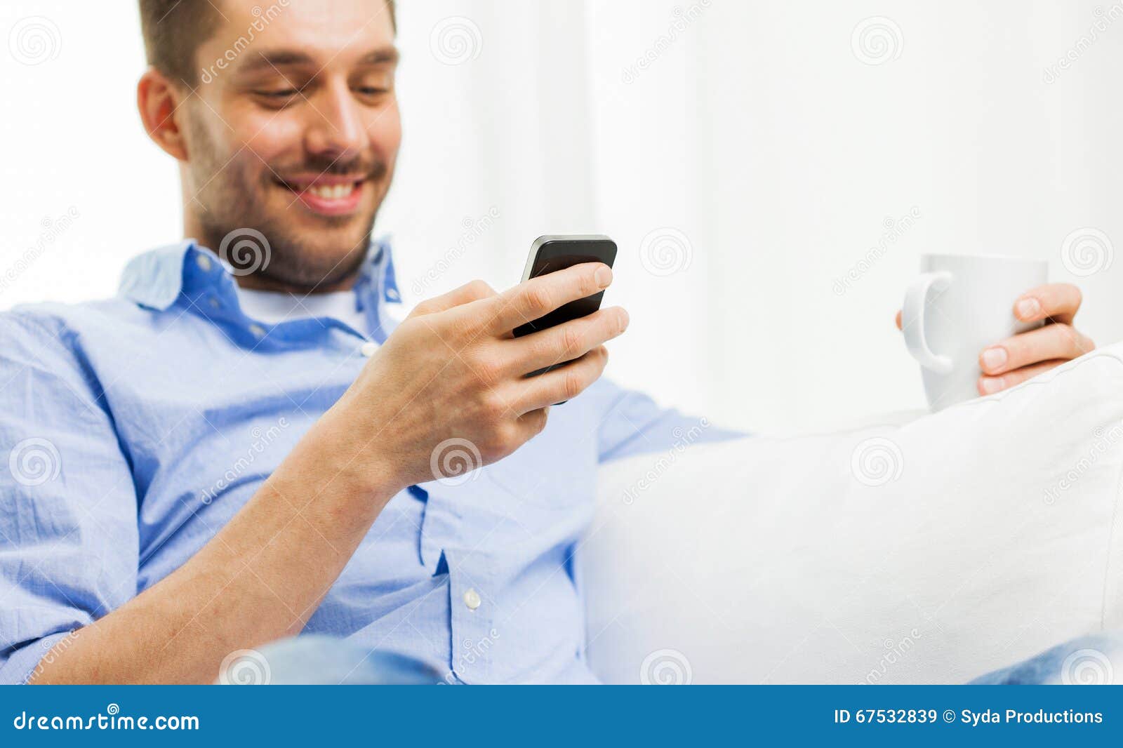 Smiling Man Texting Message on Smartphone at Home Stock Image - Image ...