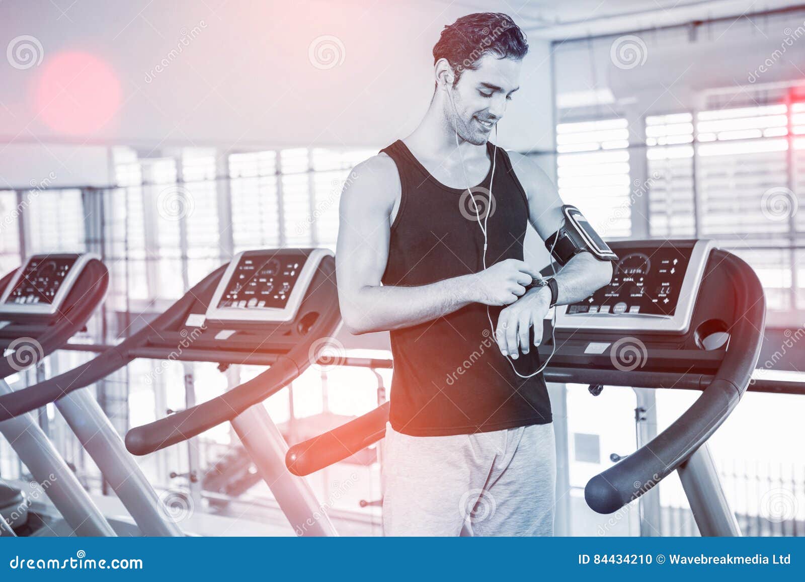 Smiling Man on Treadmill Using Smart Watch Stock Photo - Image of ...