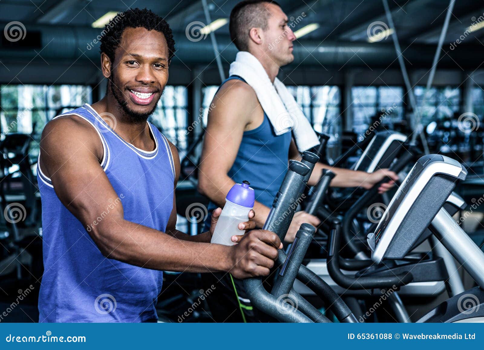 Smiling Man Using Elliptical Machine Stock Photo - Image of happy ...