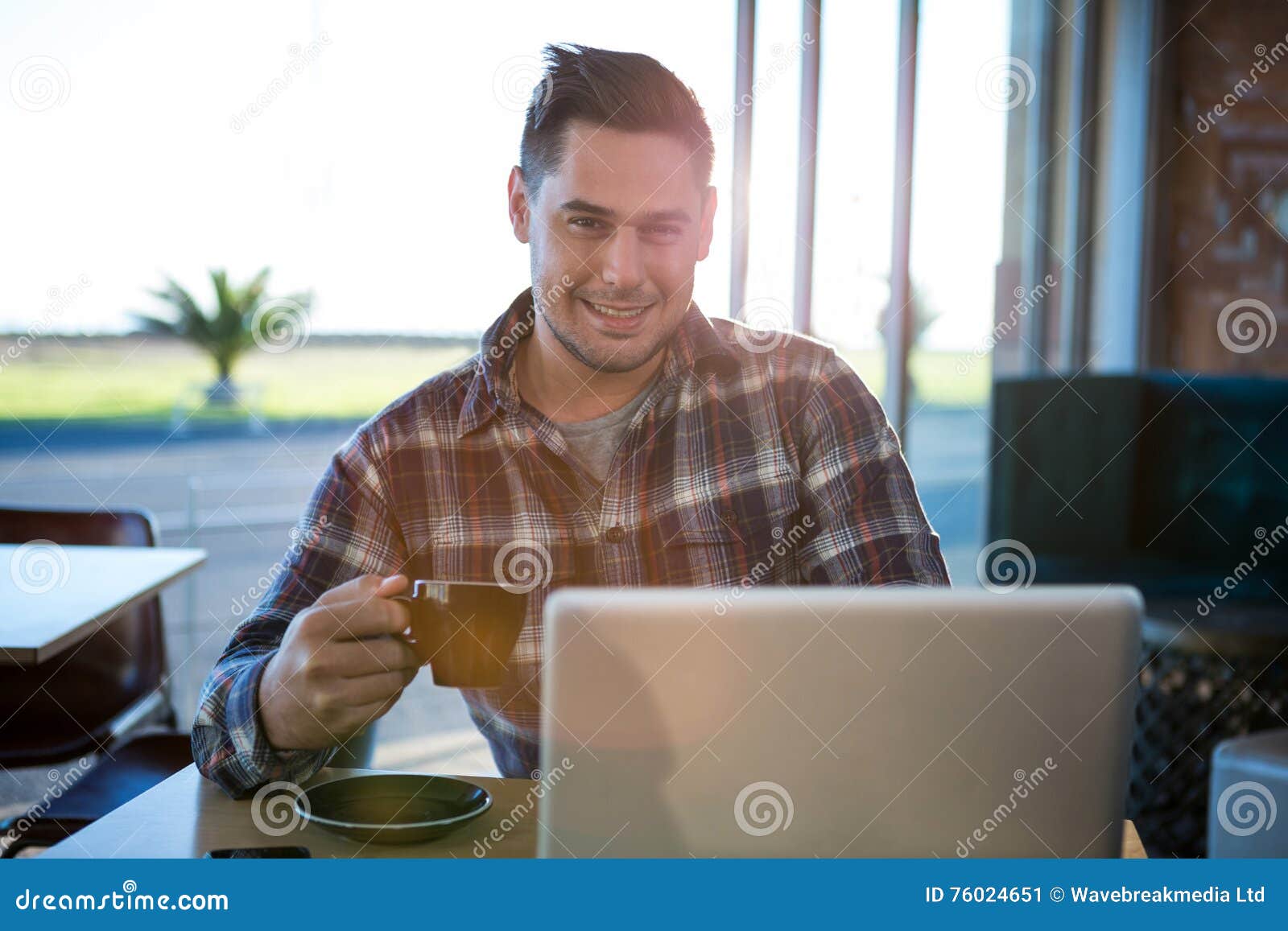 Smiling Man Using Laptop while Having Coffee Stock Image - Image of ...