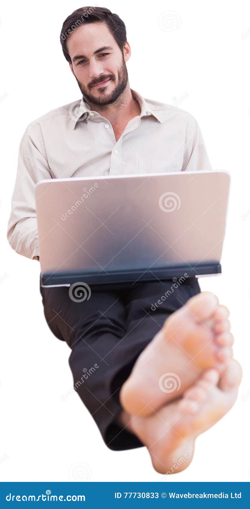 Smiling man using a laptop stock image. Image of sitting - 77730833